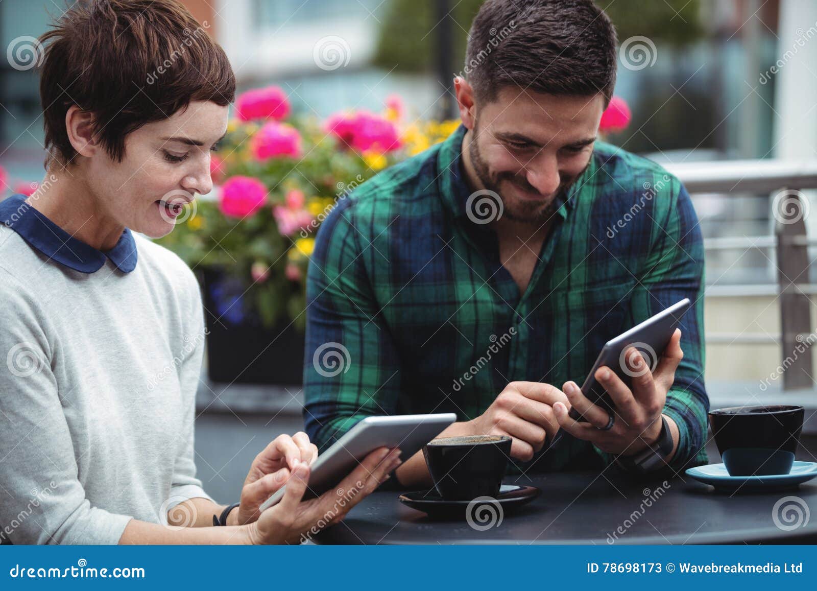 Businesspeople Using Digital Tablet while Having Coffee Stock Image ...