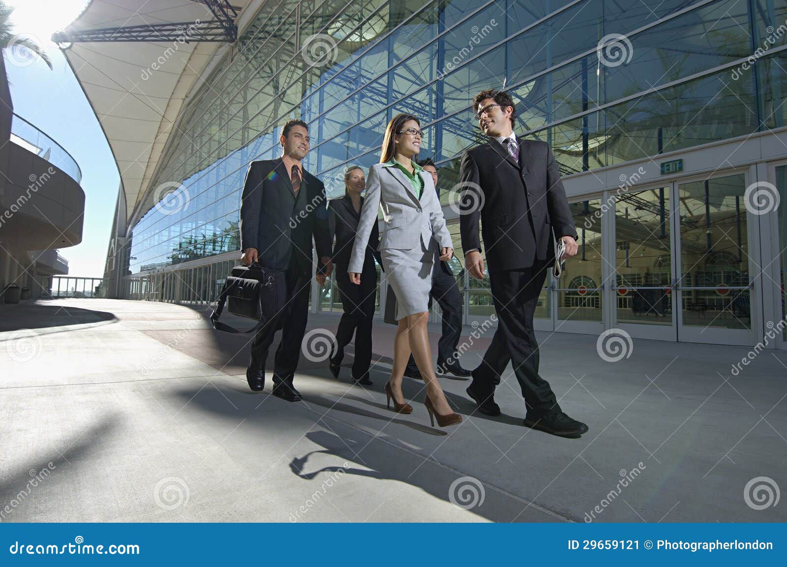 Businesspeople Walking Past Office Building Stock Image - Image of ...