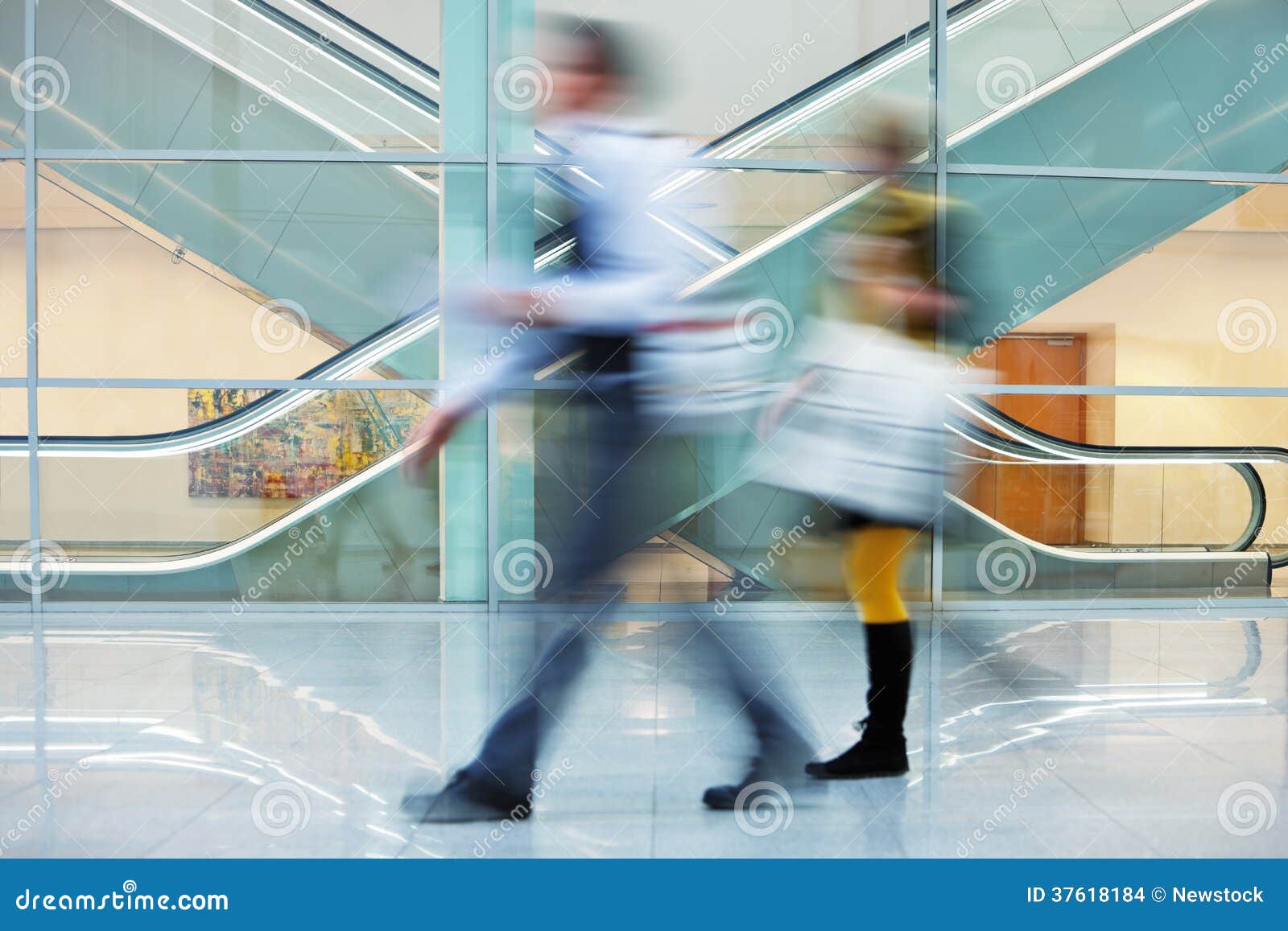 Businesspeople Walking Quickly with Luggage Down Hall in Office Stock ...