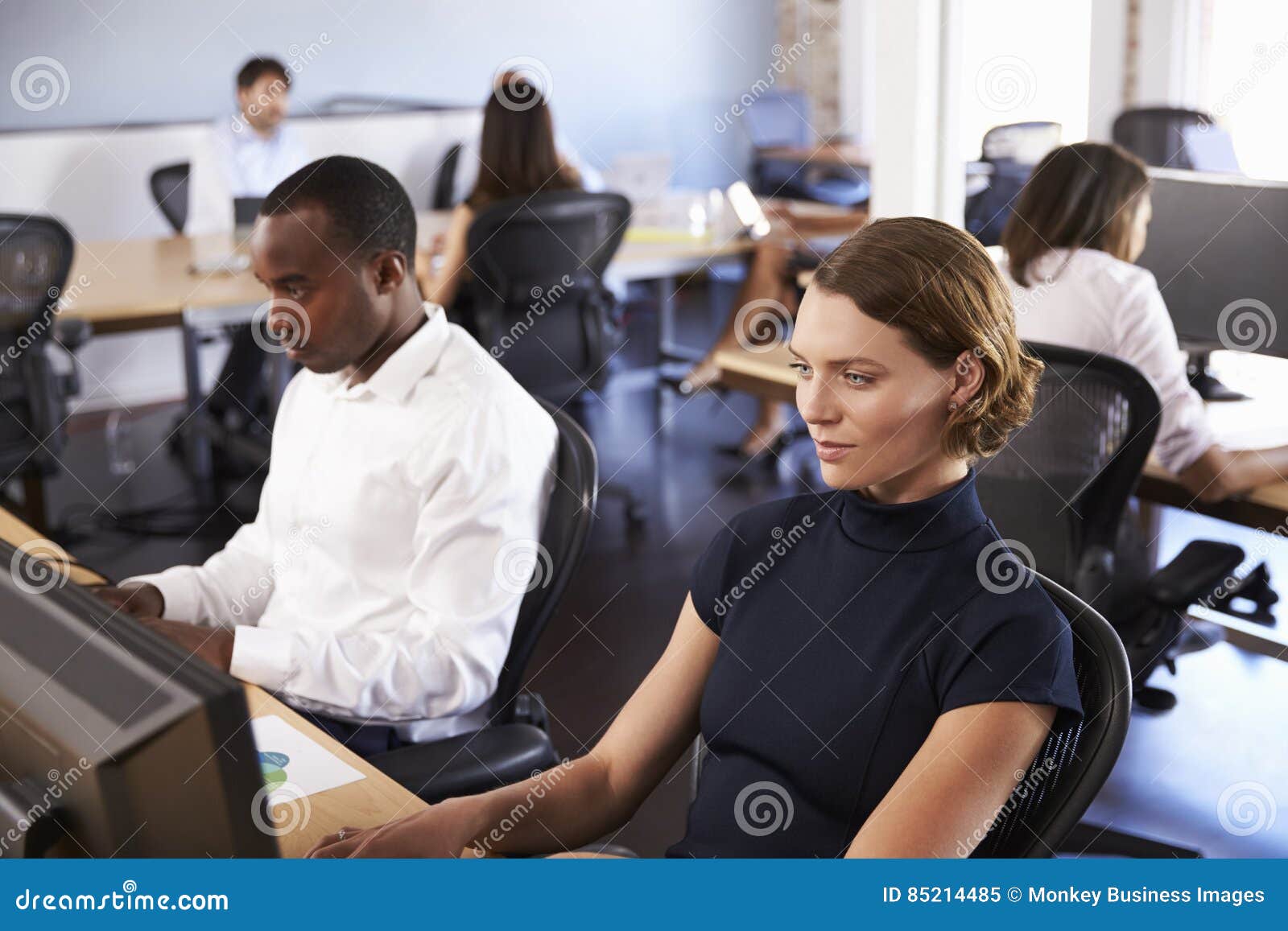 Businesspeople Working at Computers in Busy Modern Office Stock Image ...