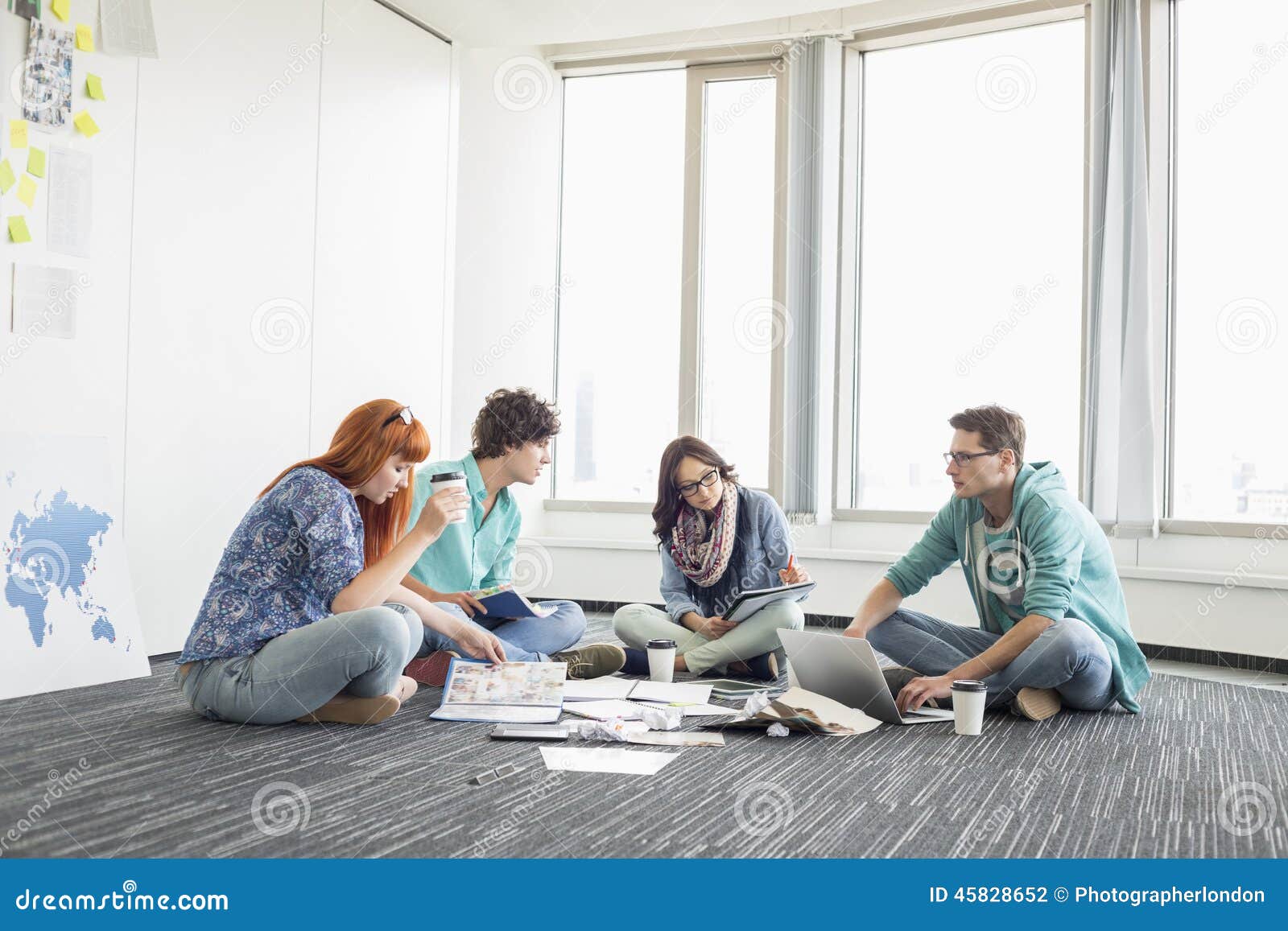 Businesspeople Working on Floor at Creative Work Space Stock Photo ...