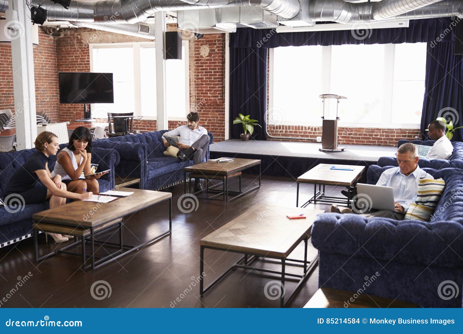Businesspeople Working in Relaxation Area of Modern Office Stock Photo ...
