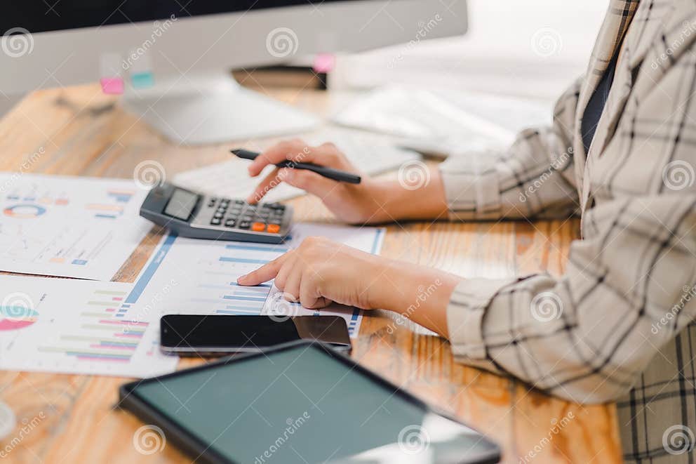 Businessperson Calculating Budget with Calculator and Analyzing ... Businessperson Calculating Budget with Calculator and Analyzing ...