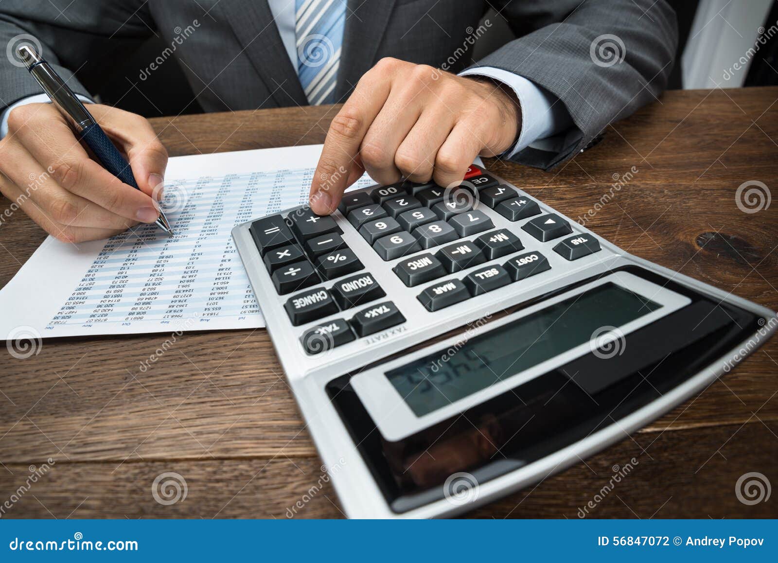 Businessperson Doing Calculation in Office Stock Photo - Image of ...