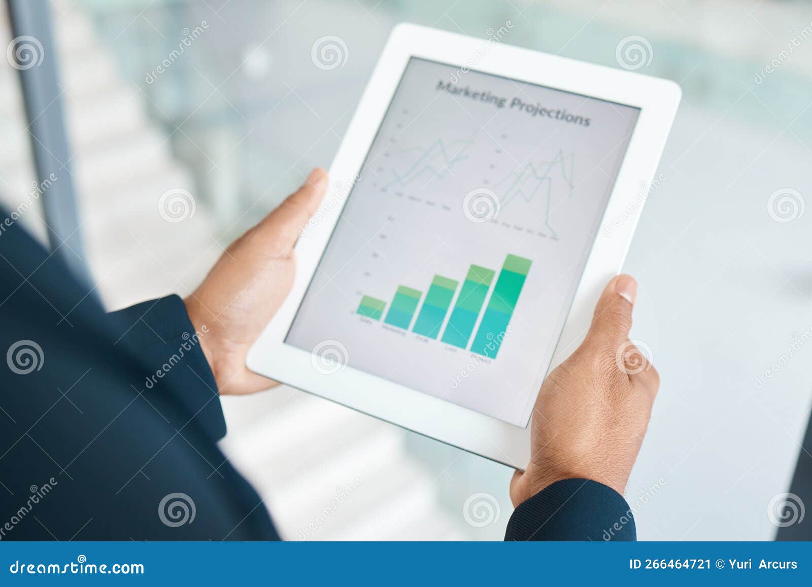 Businessperson Standing Looking at Data and Stats Holding and Using a ...