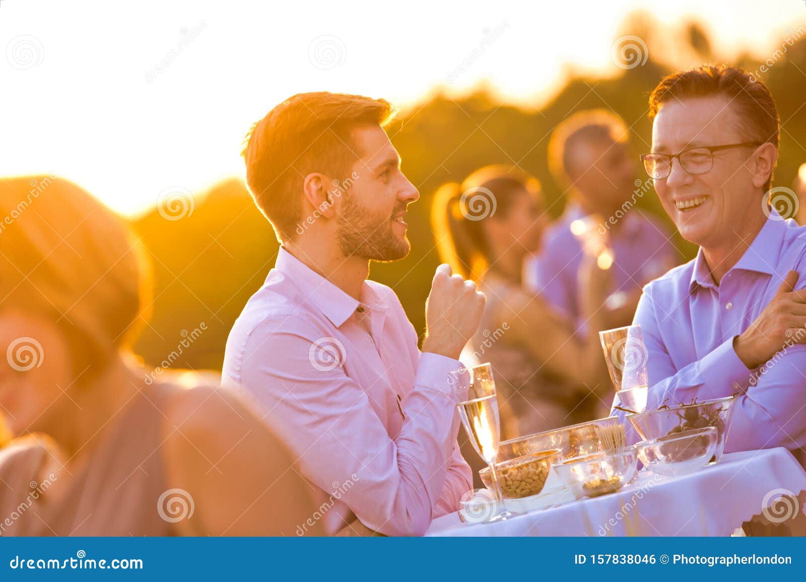 Businesss Colleagues Standing while Talking on Table at Rooftop Stock ...