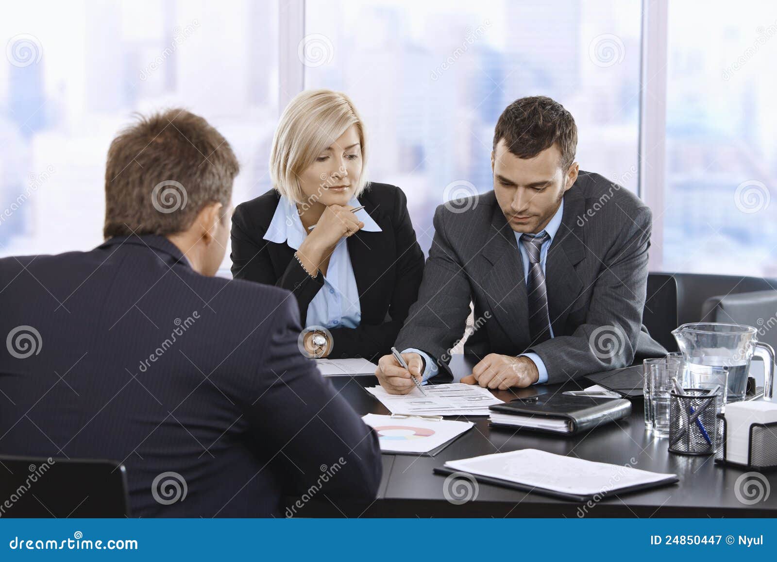 Businessteam Reviewing Documents Stock Image - Image of color, focusing ...