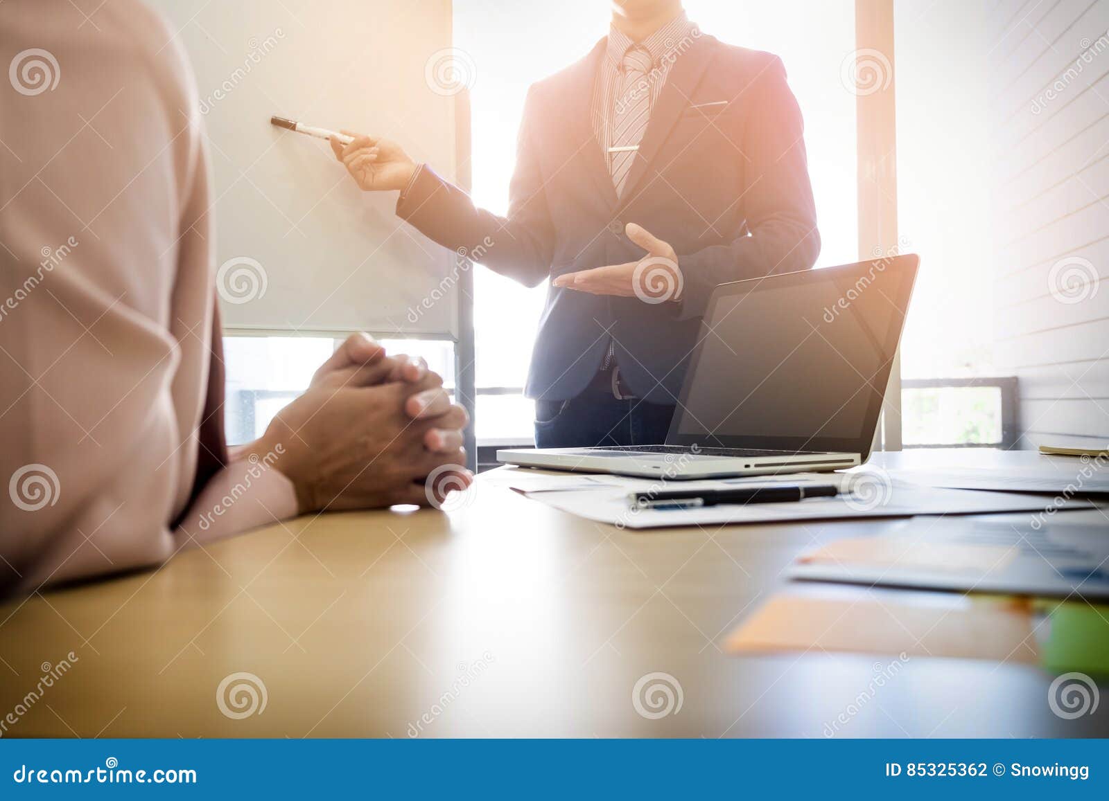 Businesswoman Asking Question during Her Colleagues Presentation Stock ...