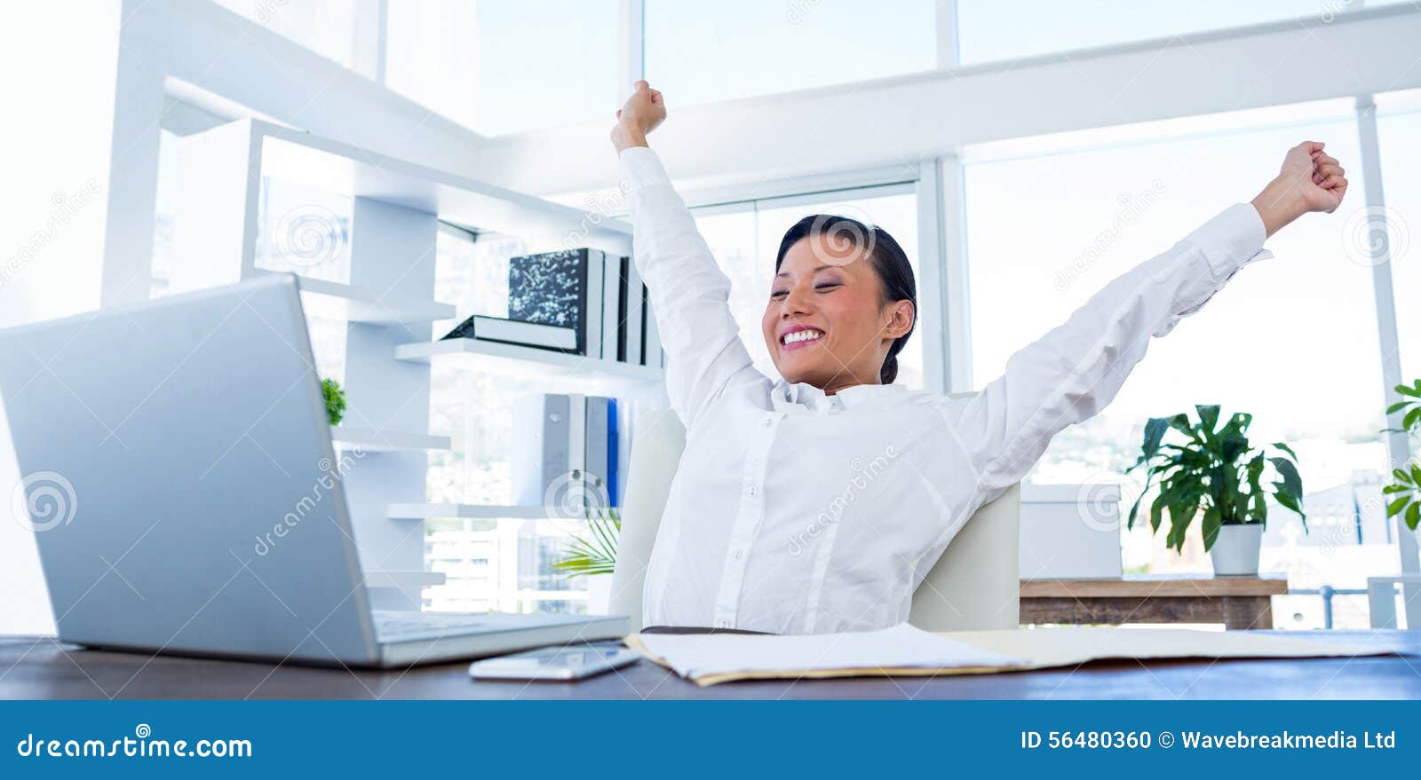Businesswoman Cheering Behind Laptop Computer Stock Photo - Image of ...