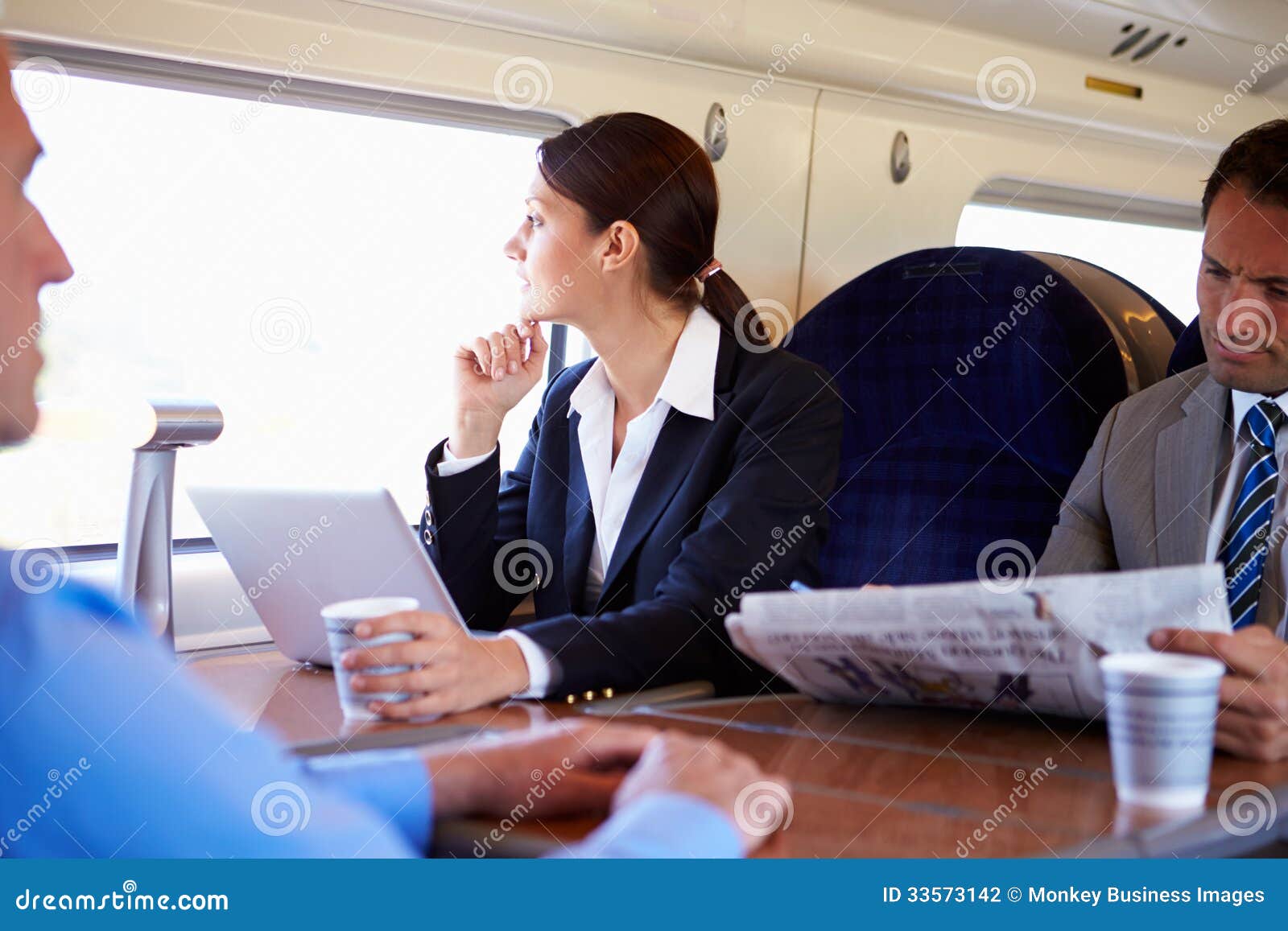 Businesswoman Commuting To Work on Train and Using Laptop Stock Photo ...