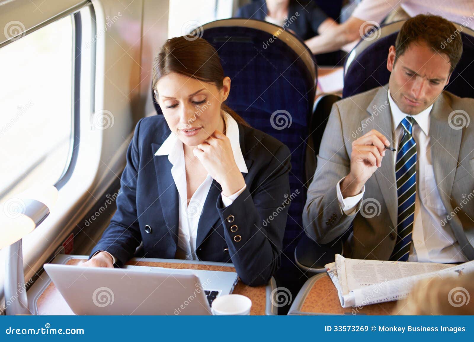 Businesswoman Commuting To Work on Train and Using Laptop Stock Image ...