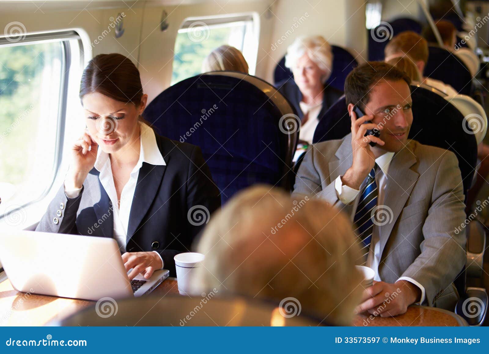Businesswoman Commuting To Work on Train and Using Laptop Stock Image ...