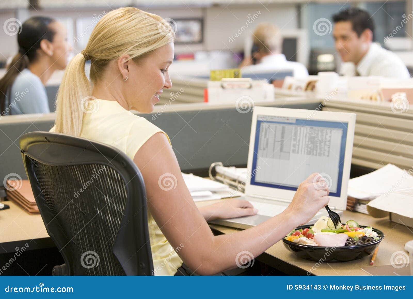 Businesswoman in Cubicle Using Laptop and Eating S Stock Image - Image ...