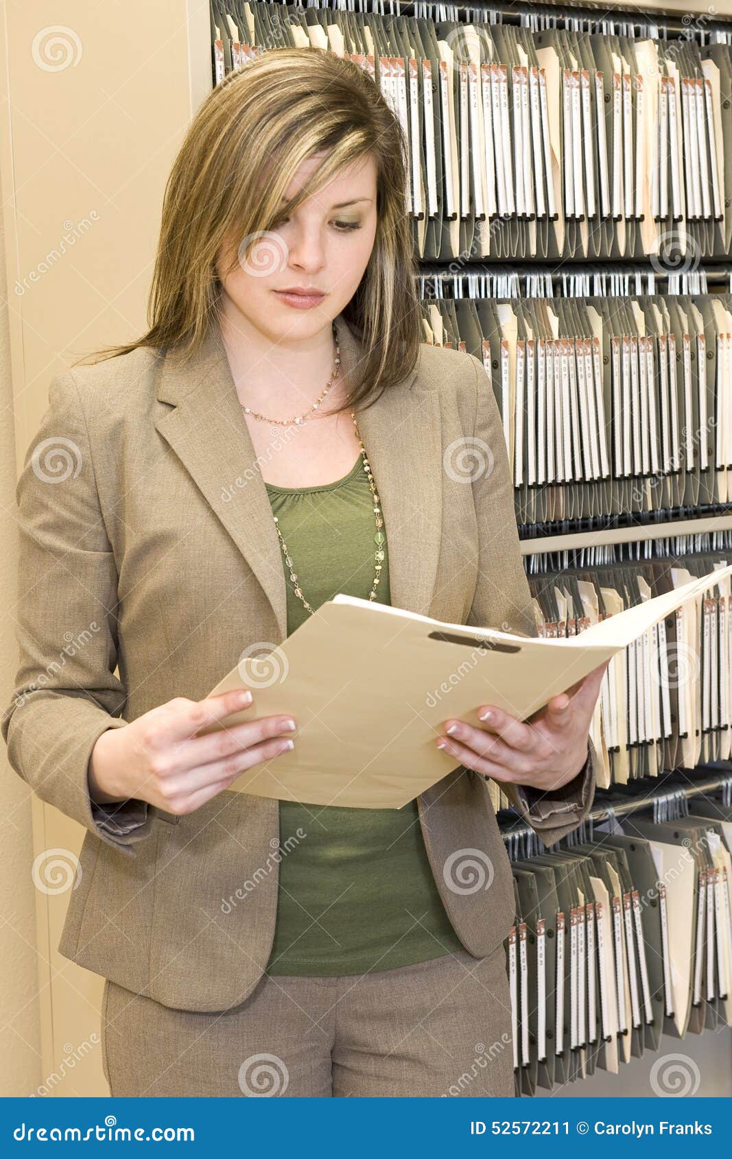 Businesswoman Examining File Folder Stock Image - Image of serious ...