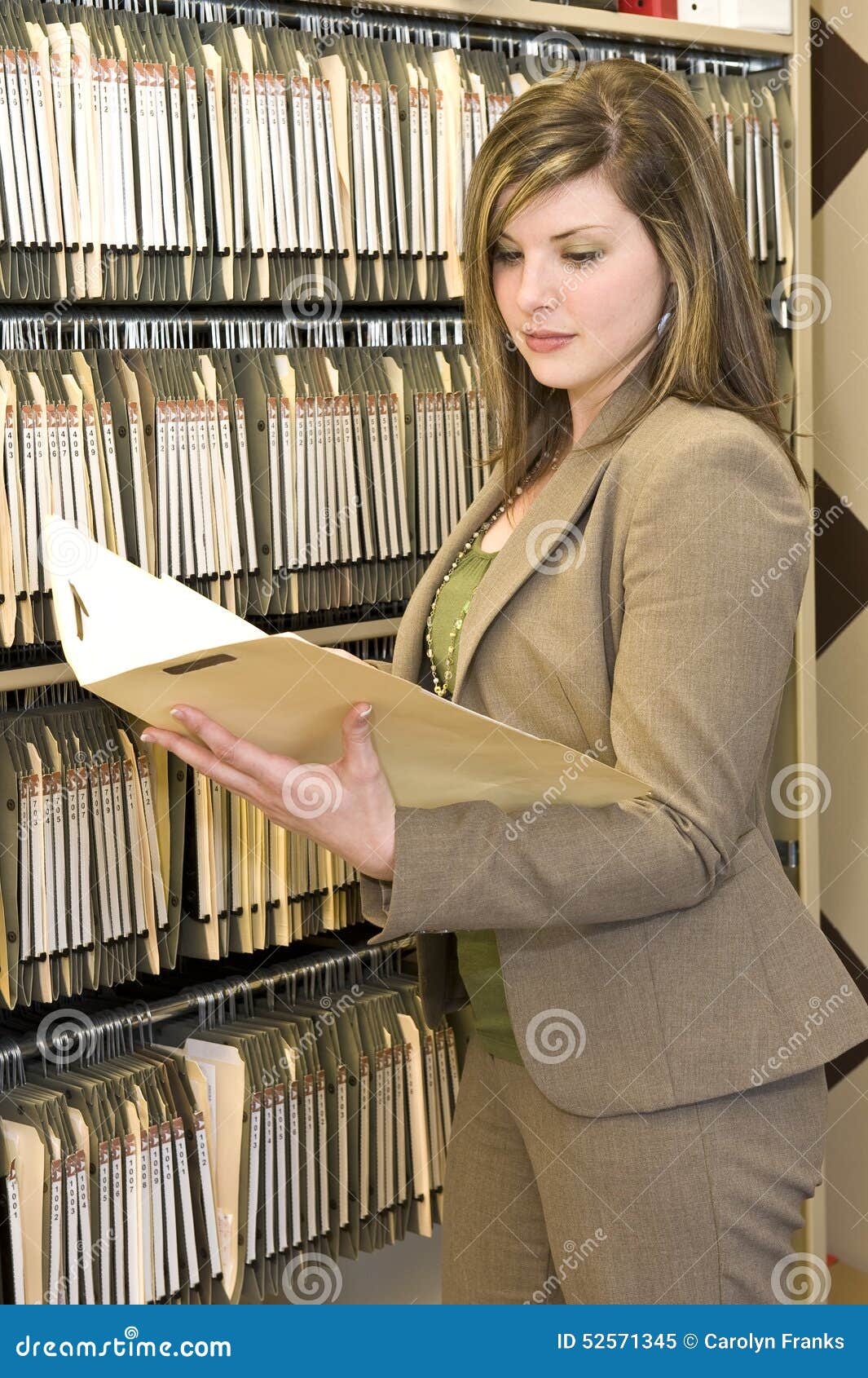 Businesswoman Examining a File Stock Image - Image of file, standing ...