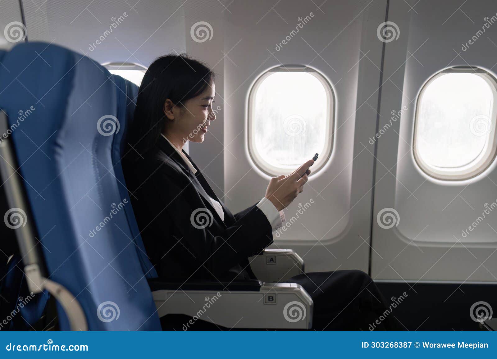 Businesswoman Flying and Working in an Airplane in First Class, Sitting ...