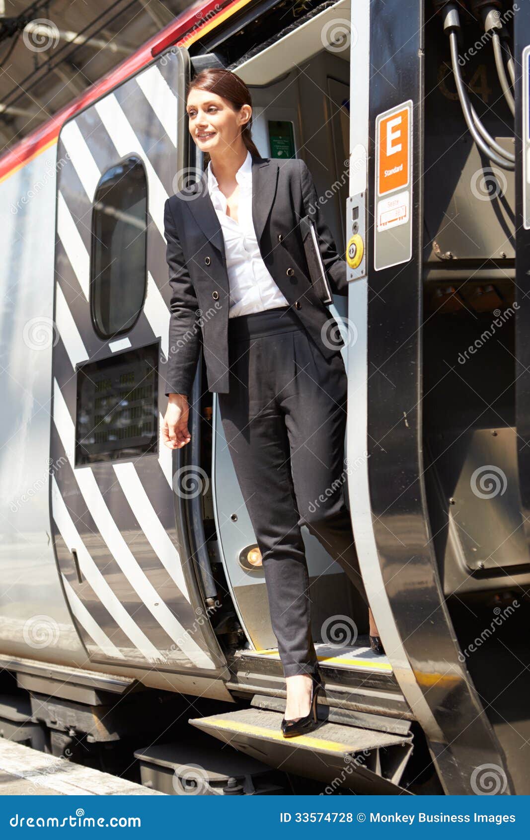 Businesswoman Getting Off Train at Platform Stock Photo - Image of ...