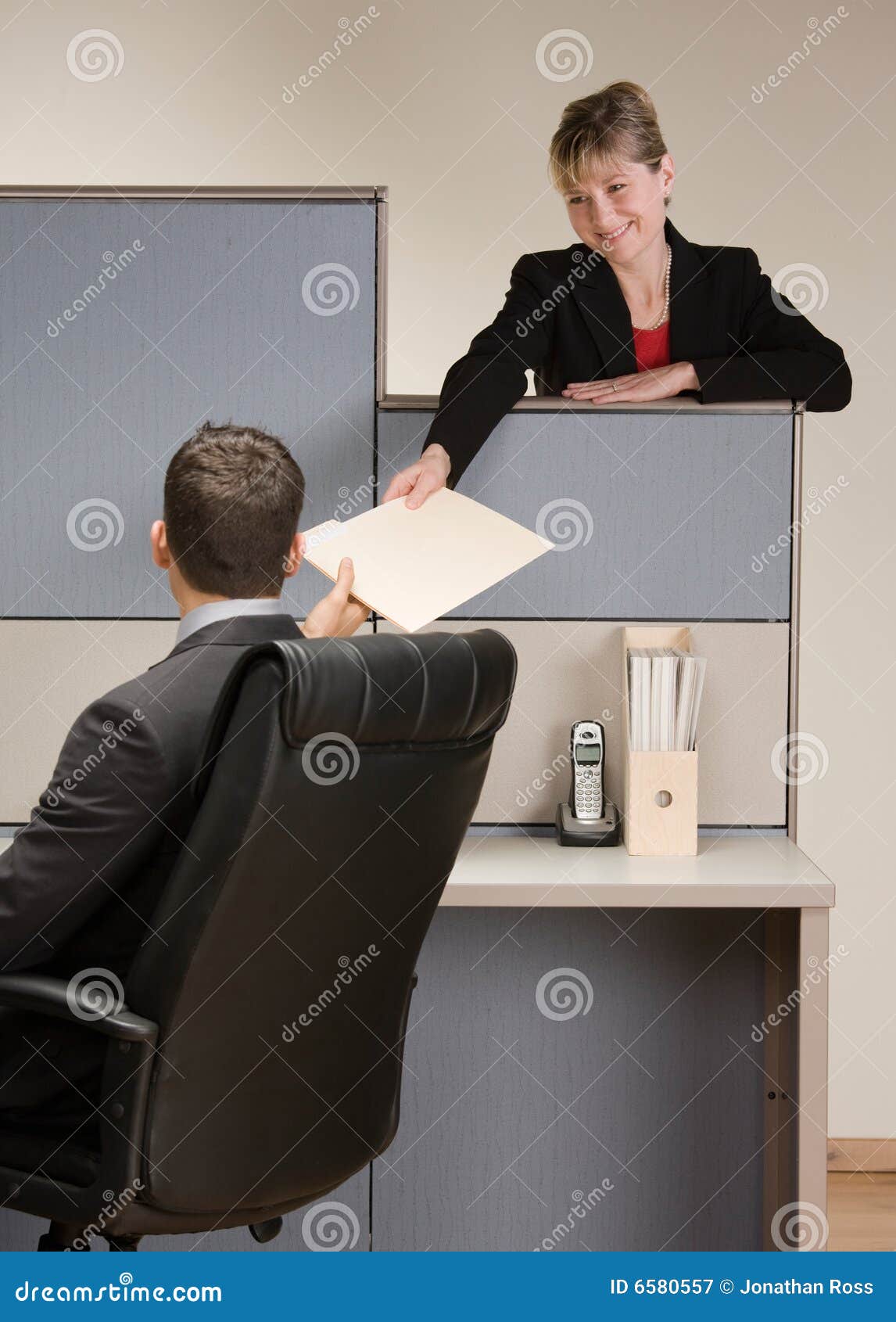 Businesswoman Handing Co-worker File Folder Stock Image - Image of ...