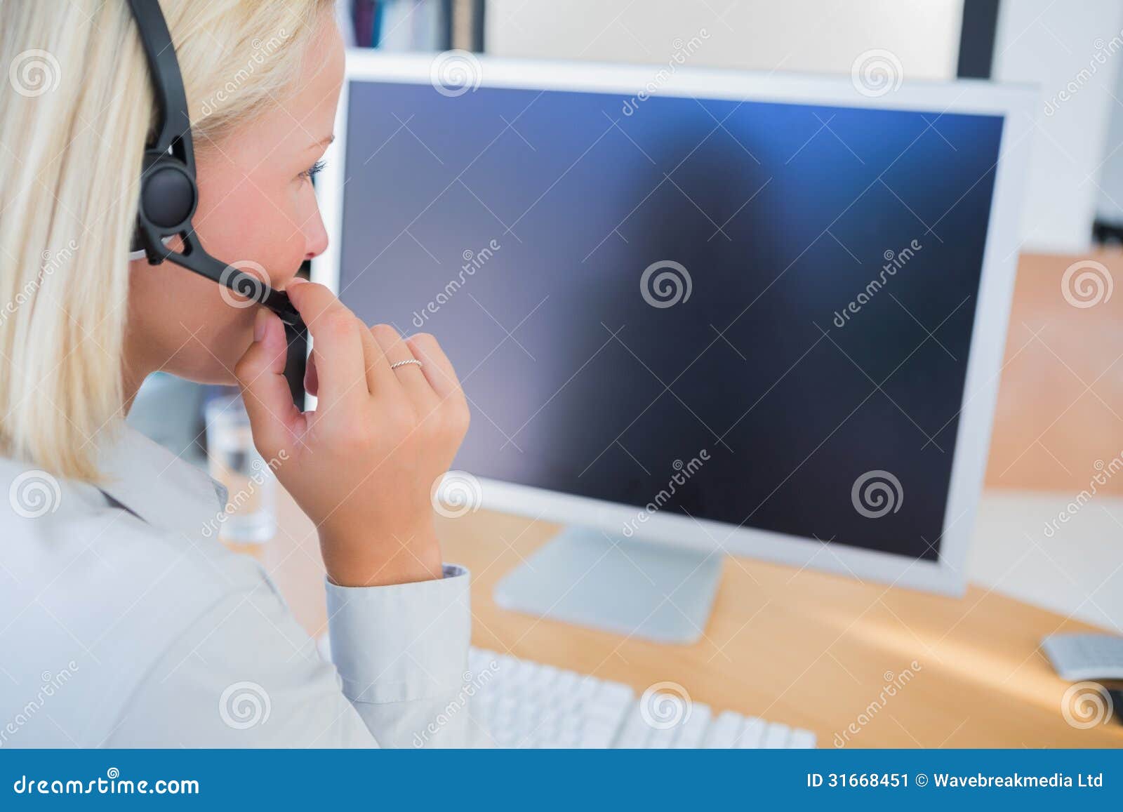 Businesswoman with Headset Looking at Computer Screen Stock Image ...