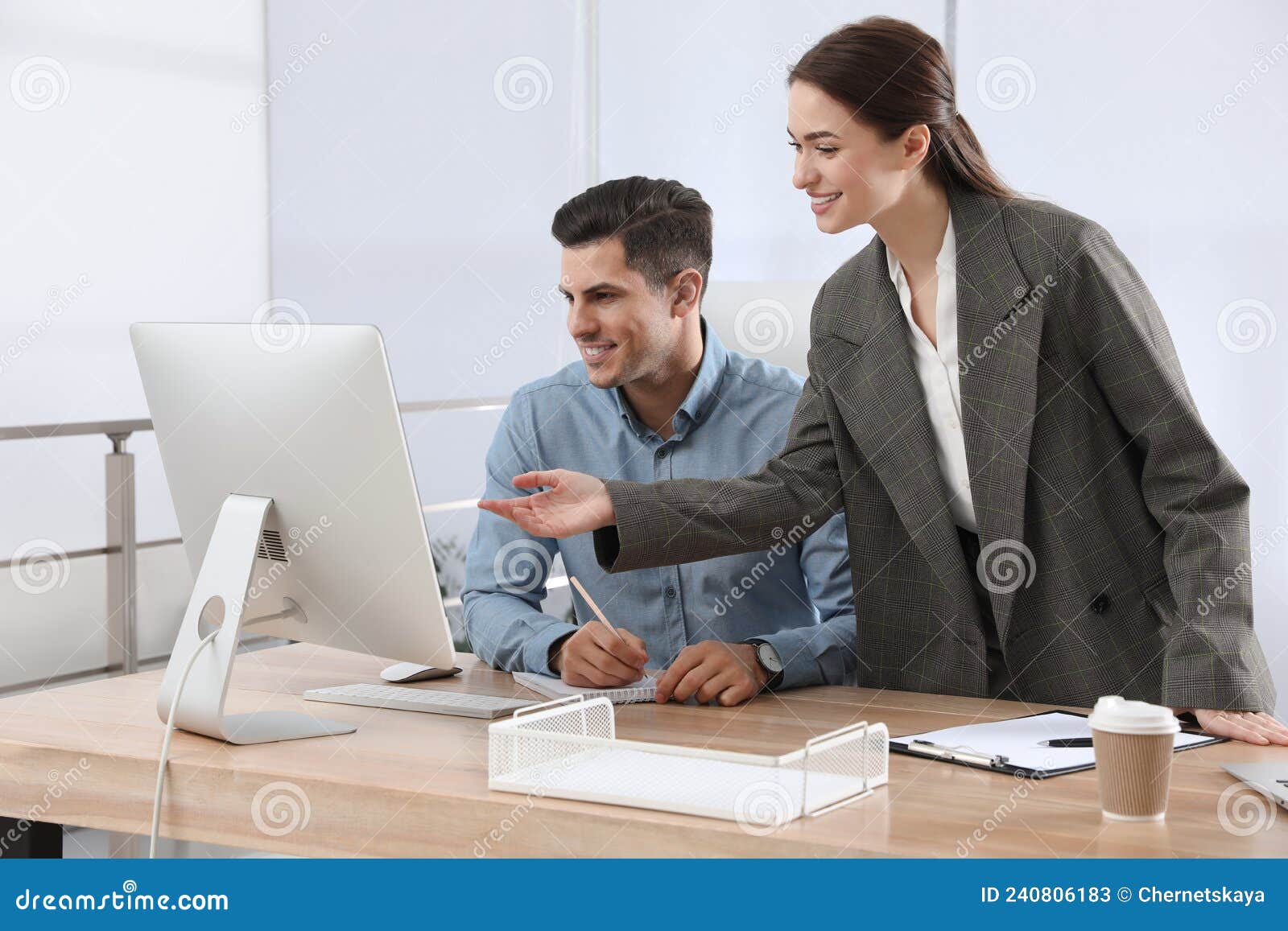 Businesswoman Helping Intern with Work in Office Stock Image - Image of ...