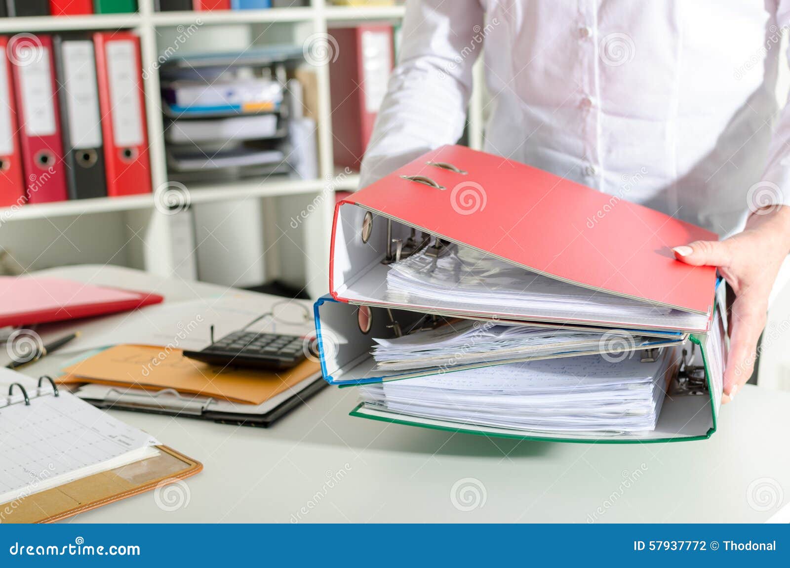 Businesswoman Holding Binders Stock Photo - Image of folders, work ...