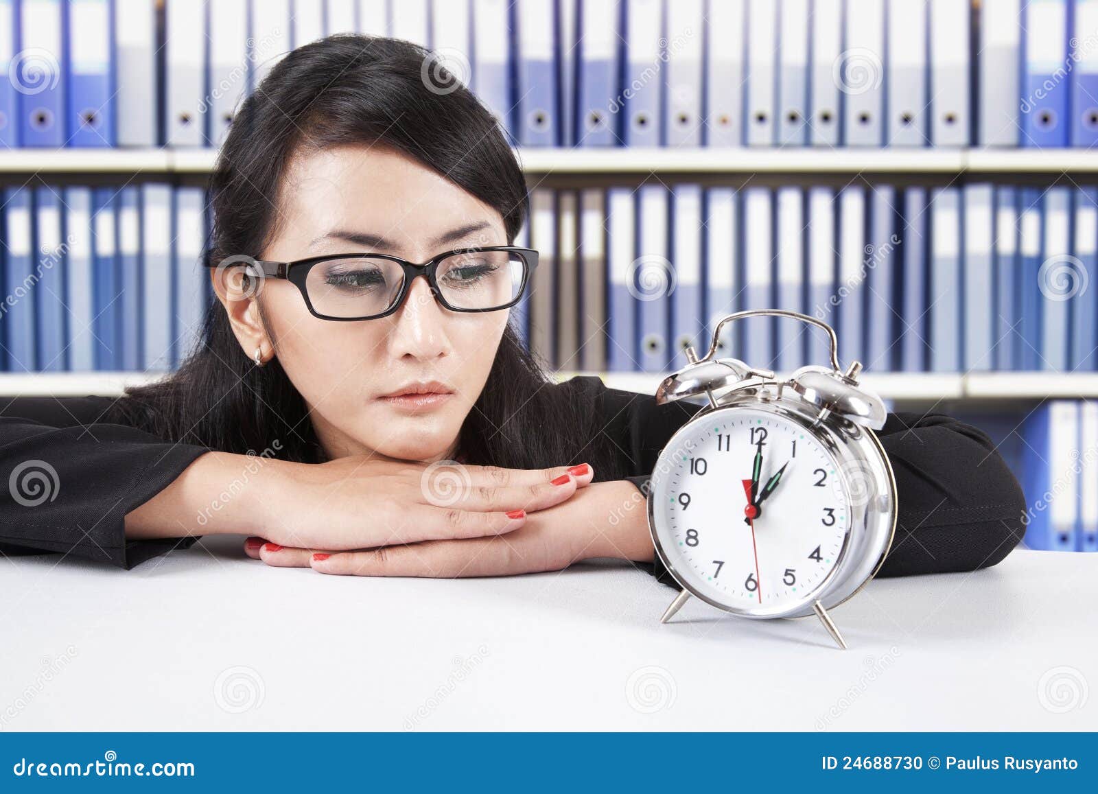 Businesswoman Looking at Alarm Clock Stock Photo - Image of face, clock ...
