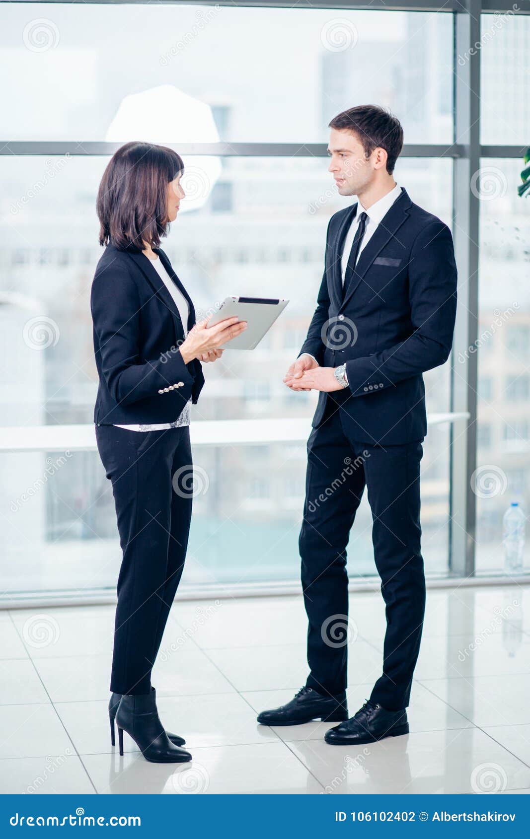 Businesswoman with Male Colleague Using Tablet Computer Stock Photo ...