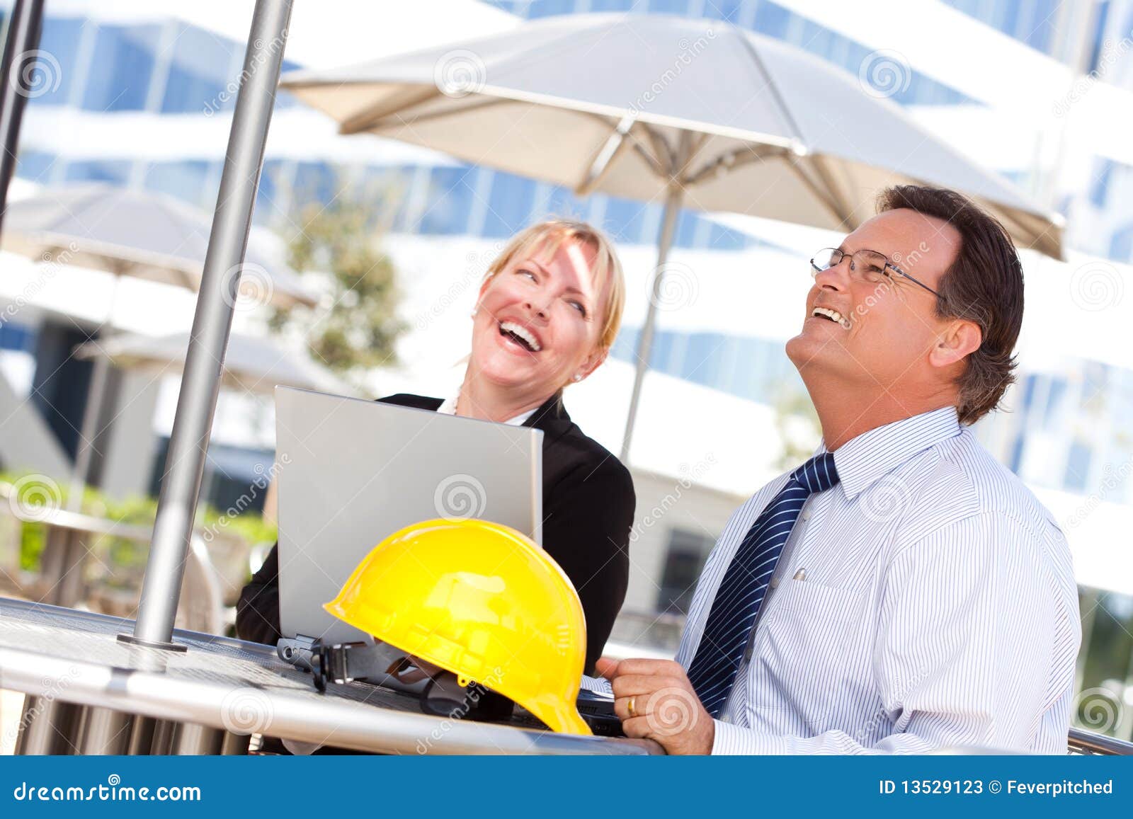 Businesswoman and Man Laughing while Working Stock Image - Image of ...