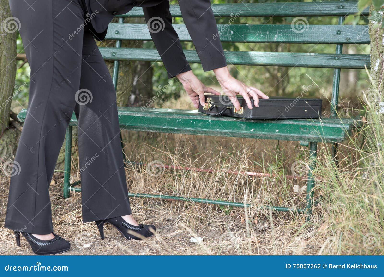 Businesswoman Opens Briefcase on a Bench Stock Photo - Image of ...