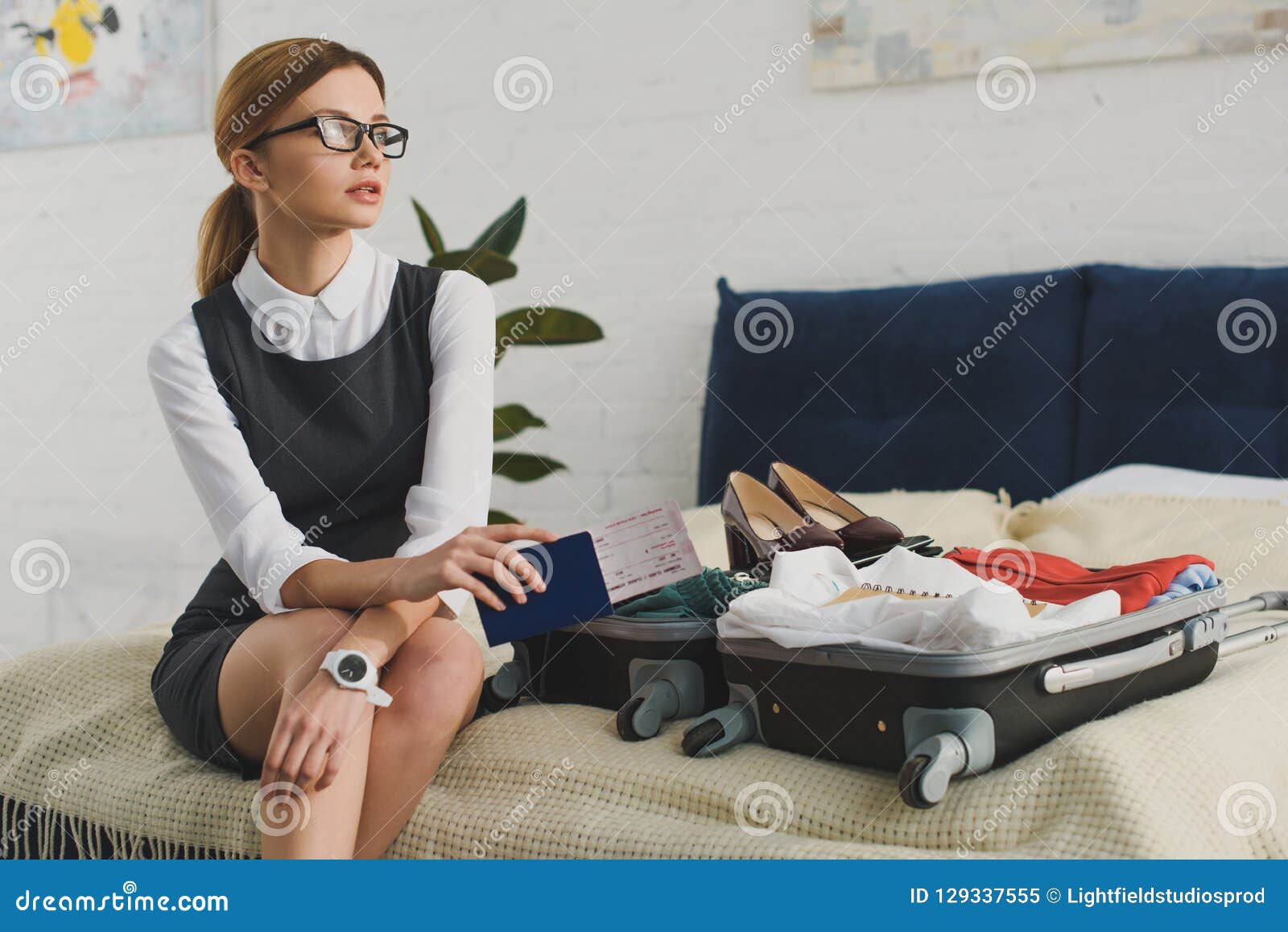 Businesswoman With Passport And Air Ticket Packing Suitcase Stock Image