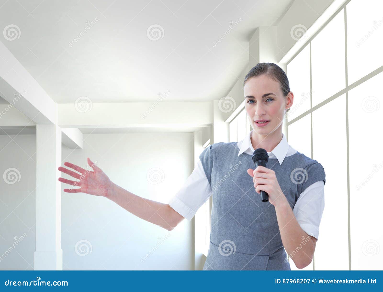 Businesswoman Public Speaking on Microphone in Office Stock Image ...