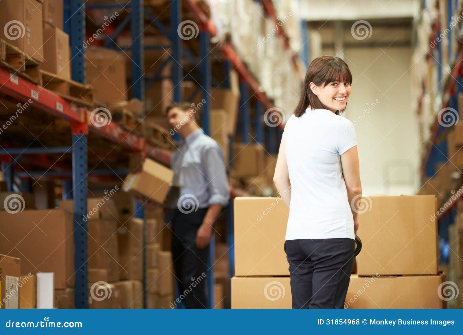 Businesswoman Pulling Pallet in Warehouse Stock Photo - Image of ...