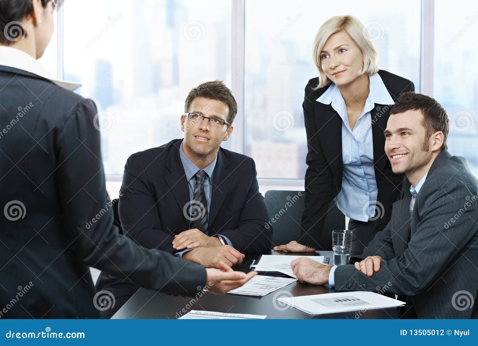 Businesswoman Reporting To Colleagues Stock Photo - Image of fourties ...