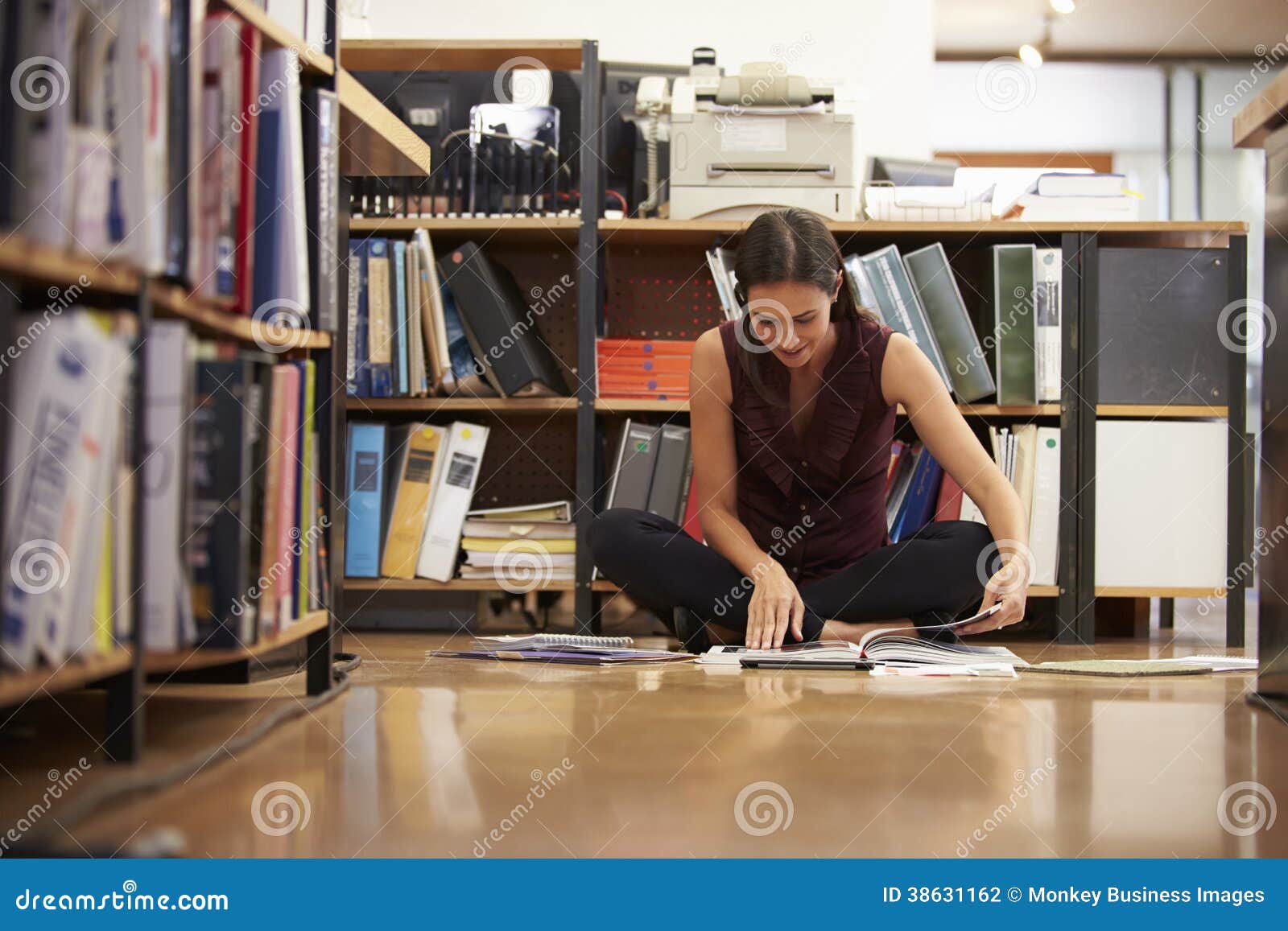 Businesswoman Sitting on Office Floor Reading Documents Stock Photo ...
