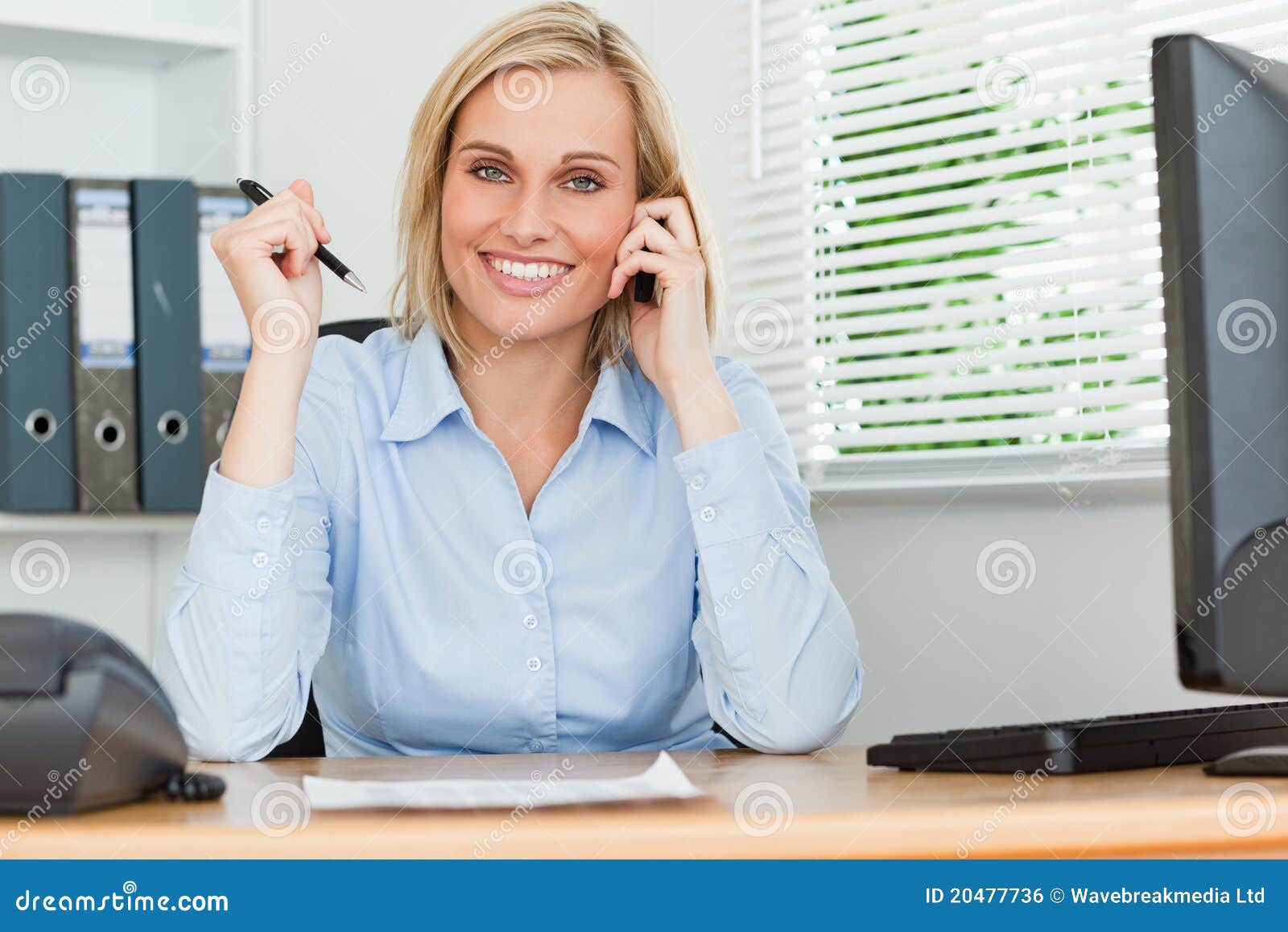 Businesswoman Smiling with Pen in Hand Stock Photo - Image of computer ...