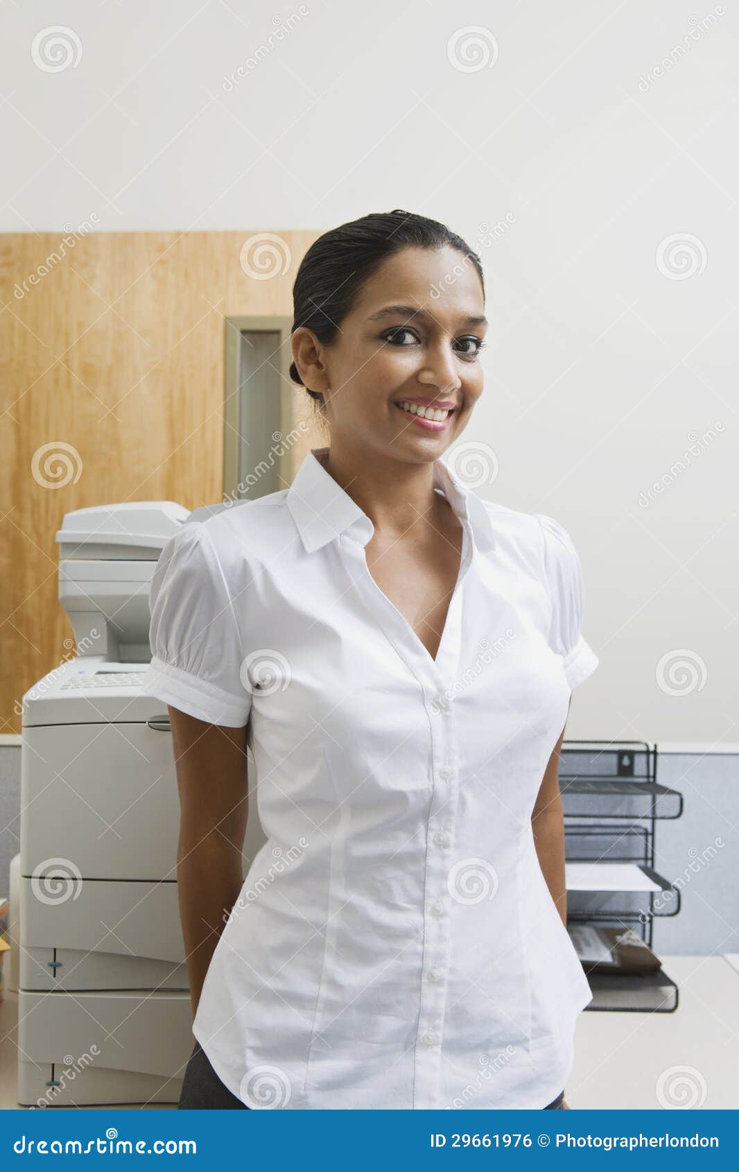 Businesswoman Standing Against Fax Machine in Office Stock Photo ...