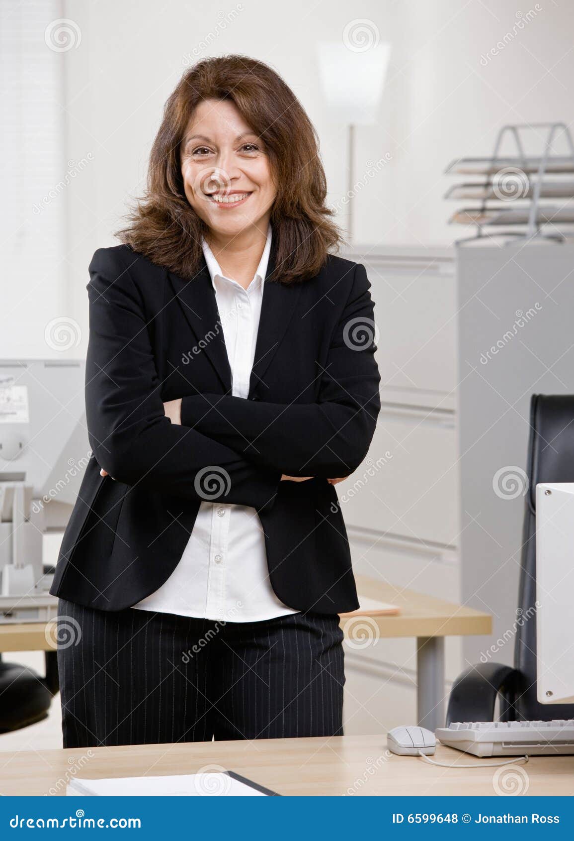 Businesswoman Standing at Desk in Office Stock Photo - Image of adult ...