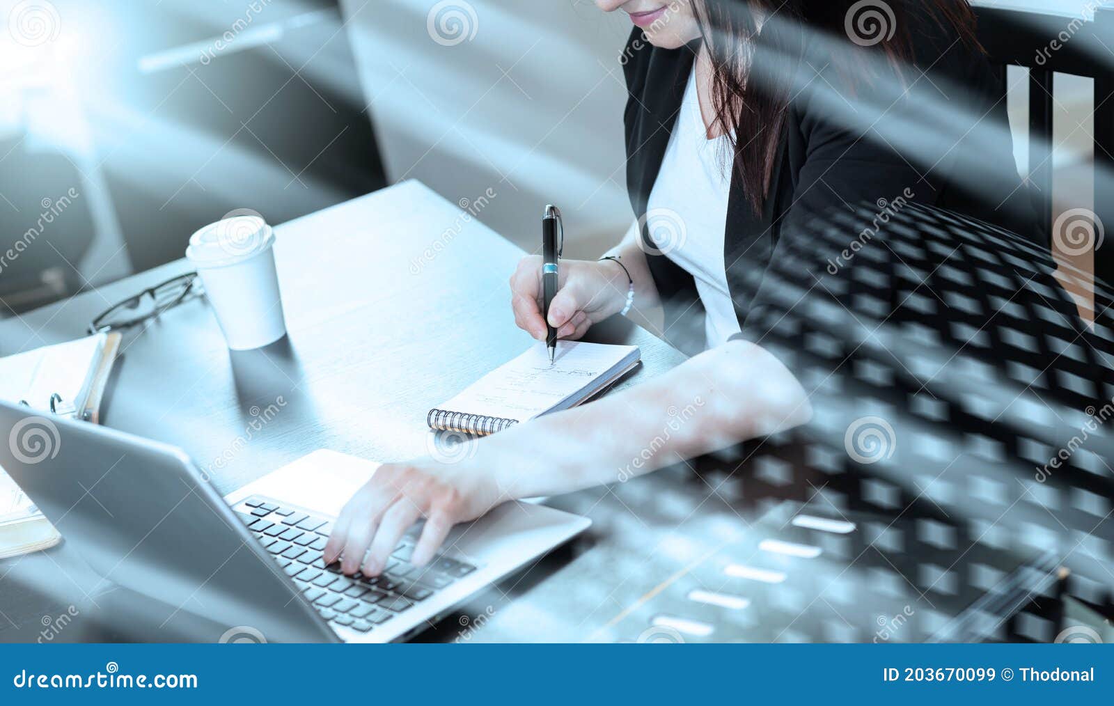 Woman Taking Notes while Using Laptop; Light Effect Stock Image - Image ...