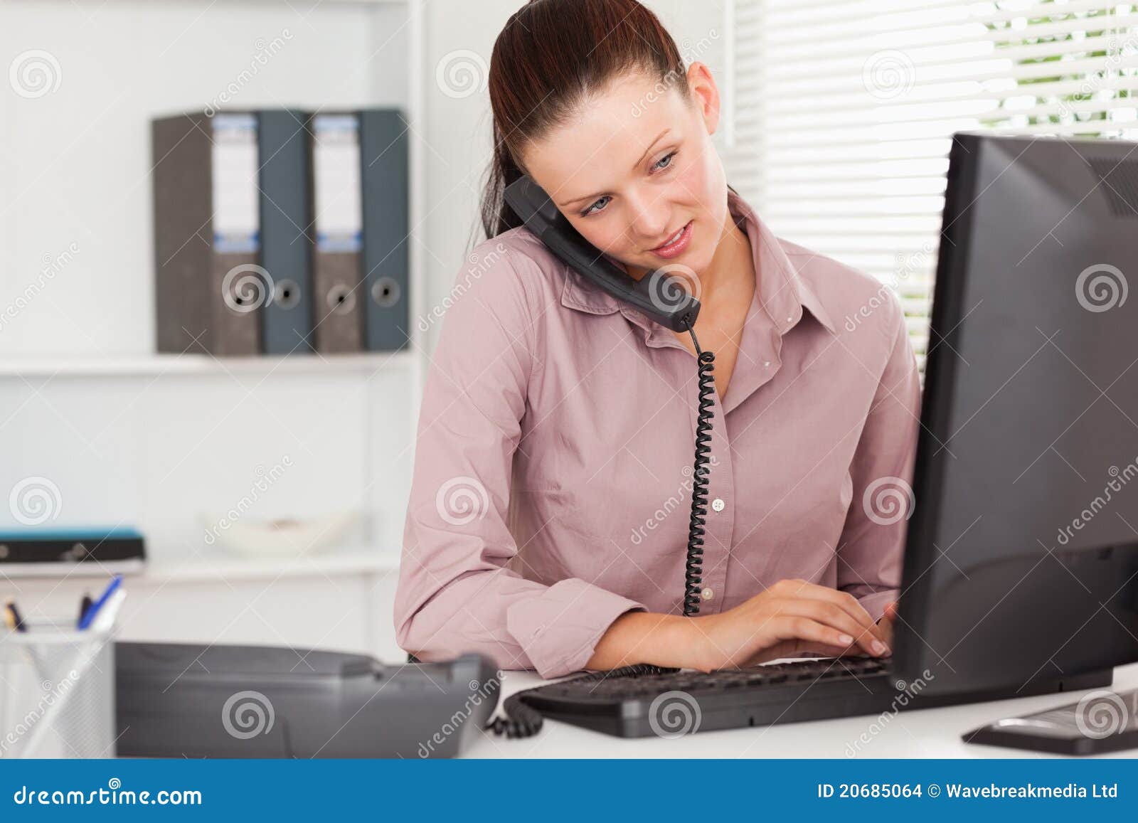 Businesswoman Telephoning and Typing Stock Photo - Image of call ...