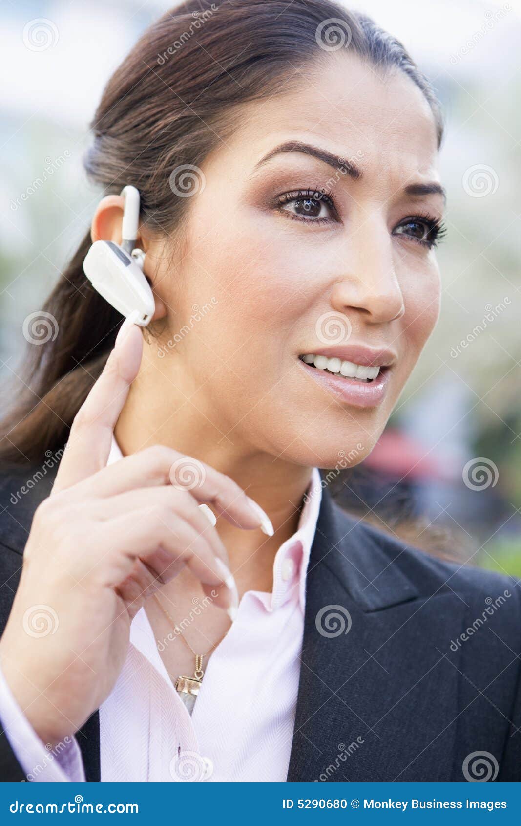 Businesswoman Using Bluetooth Earpiece Stock Photo - Image of twenties ...