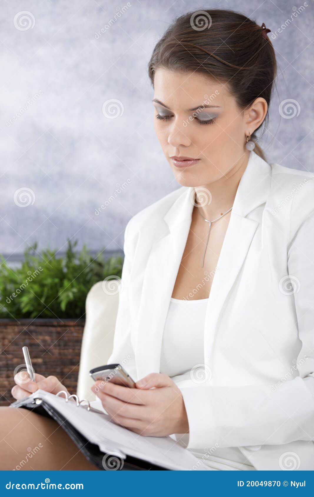 Businesswoman Using Cellphone, Writing Notes Stock Photo - Image of ...