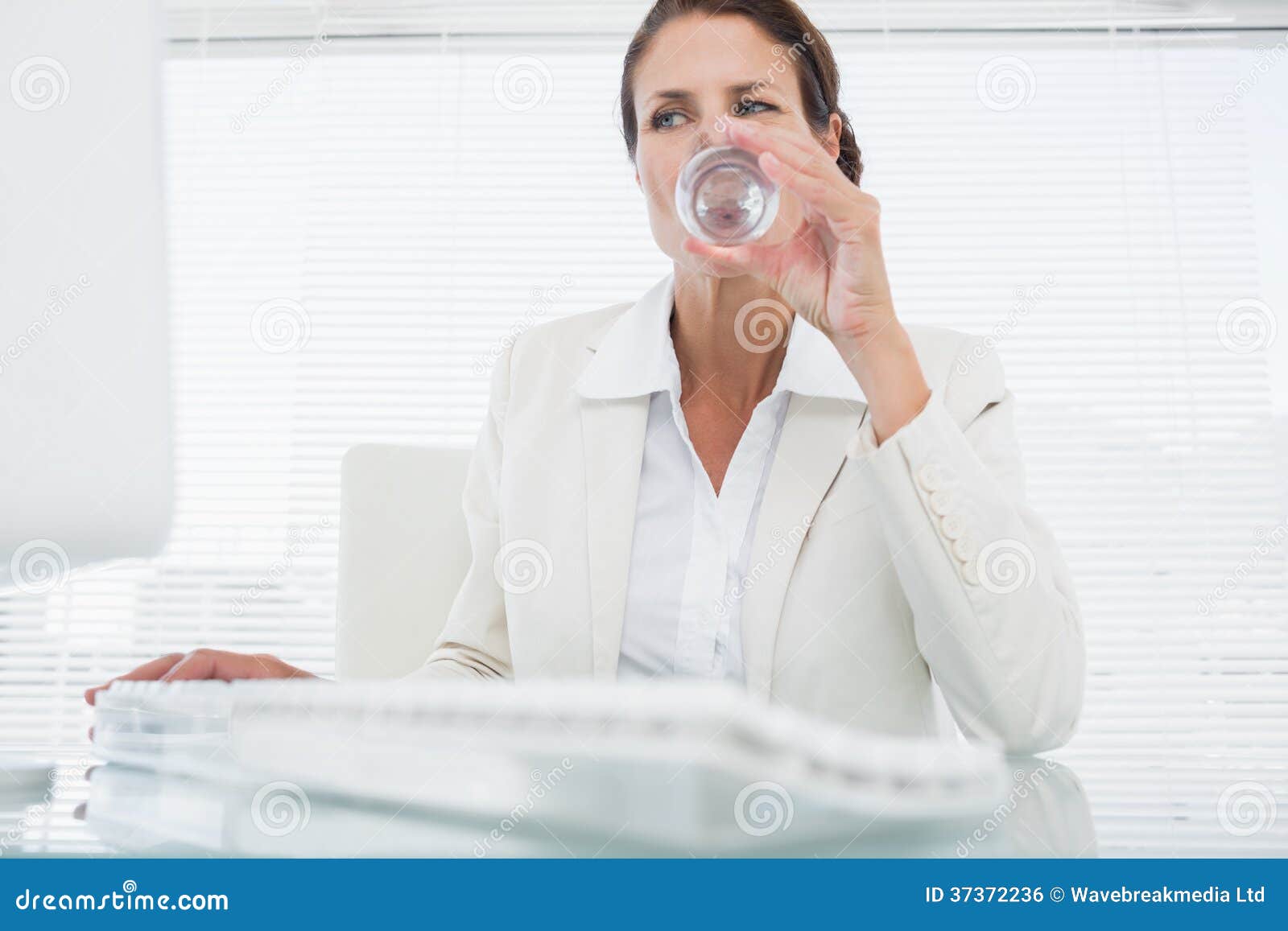 Businesswoman Using Computer while Drinking Water Stock Photo - Image ...