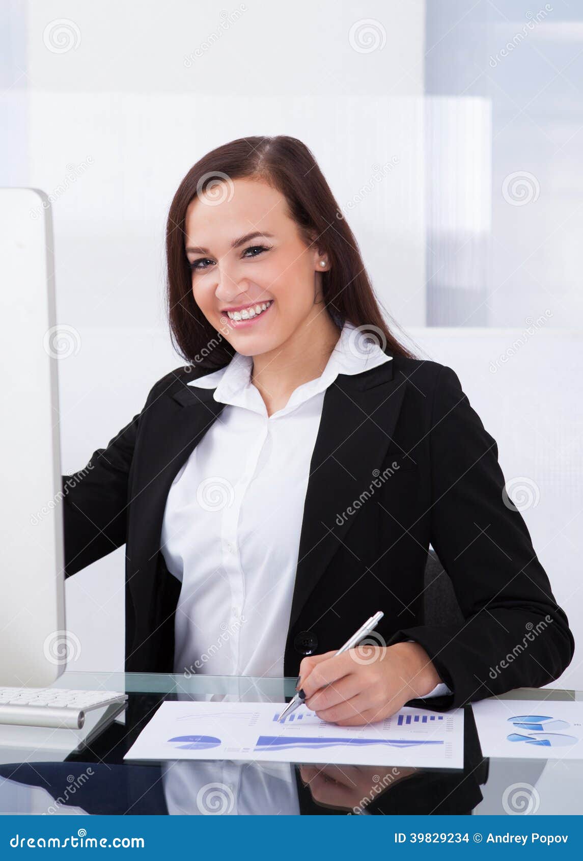 Businesswoman Using Computer in Office Stock Photo - Image of paper ...