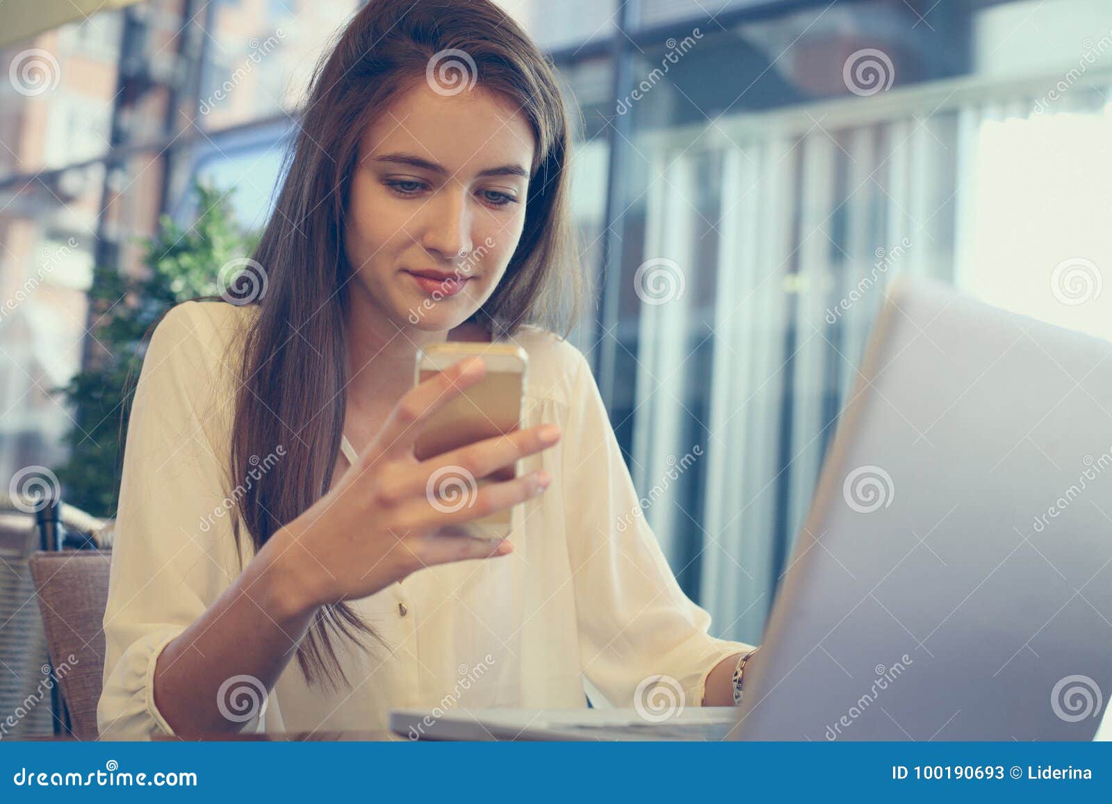 Businesswoman Using Laptop and Texting. Stock Image - Image of cell ...