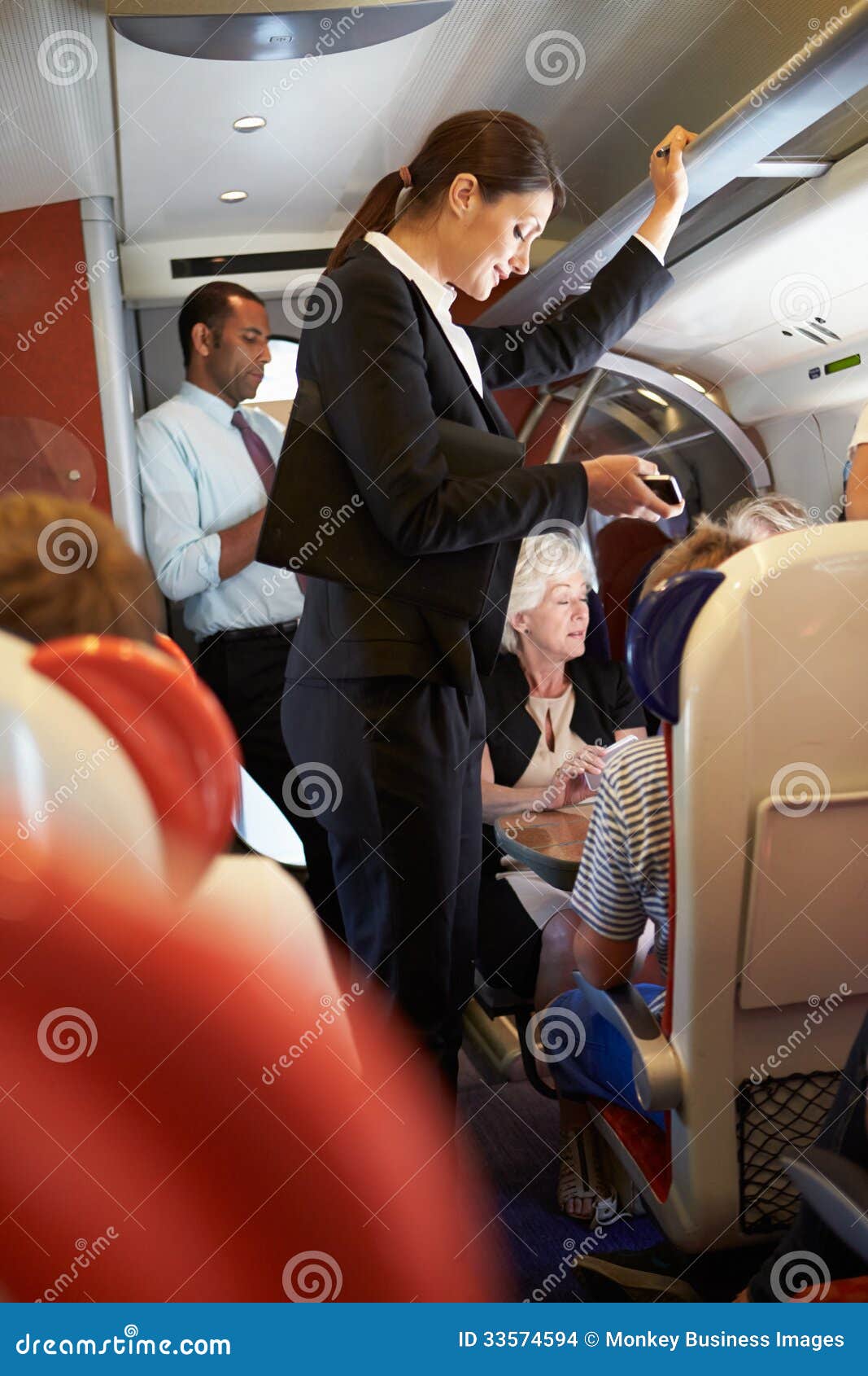 Businesswoman Using Mobile Phone on Busy Commuter Train Stock Photo ...