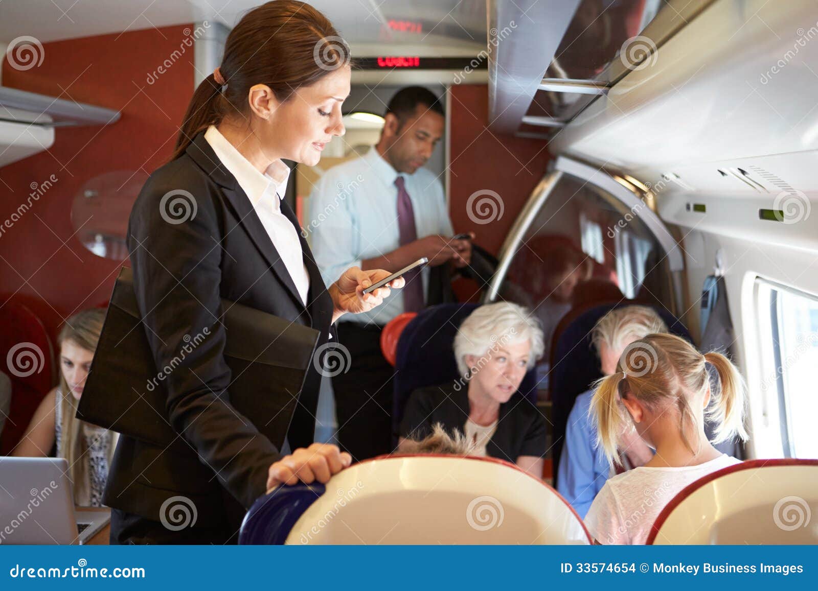 Businesswoman Using Mobile Phone on Busy Commuter Train Stock Photo ...