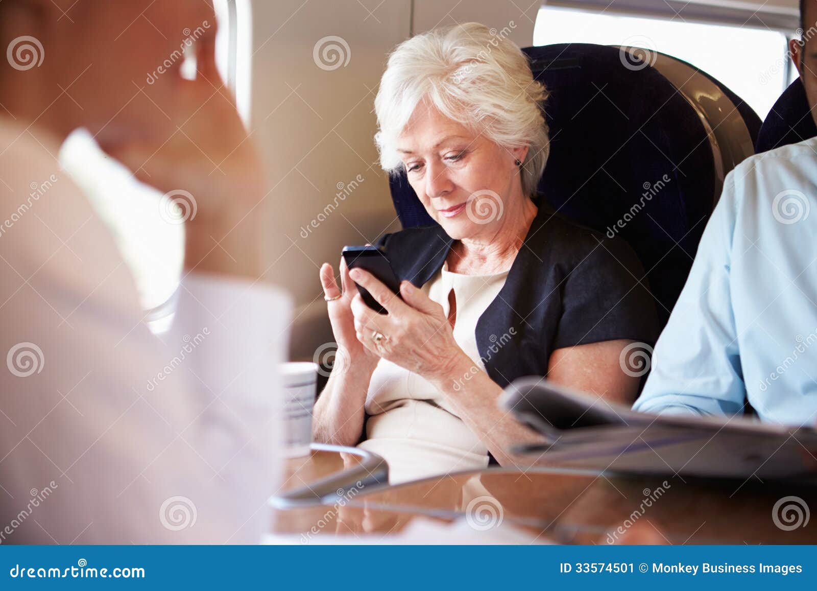 Businesswoman Using Mobile Phone on Busy Commuter Train Stock Image ...