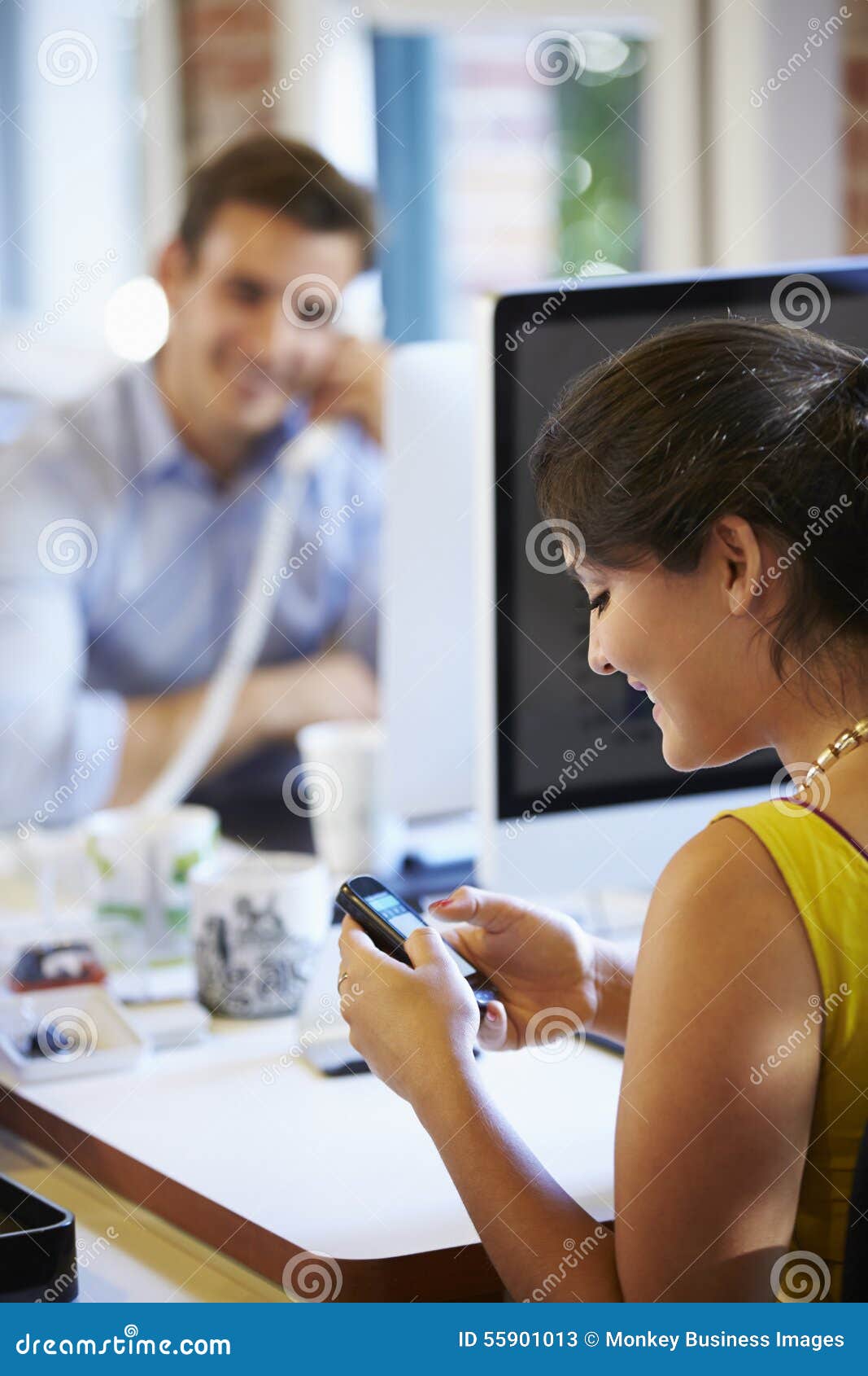 Businesswoman Using Mobile Phone in Creative Office Stock Image - Image ...