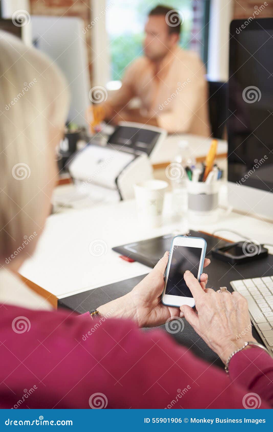 Businesswoman Using Mobile Phone in Creative Office Stock Photo - Image ...