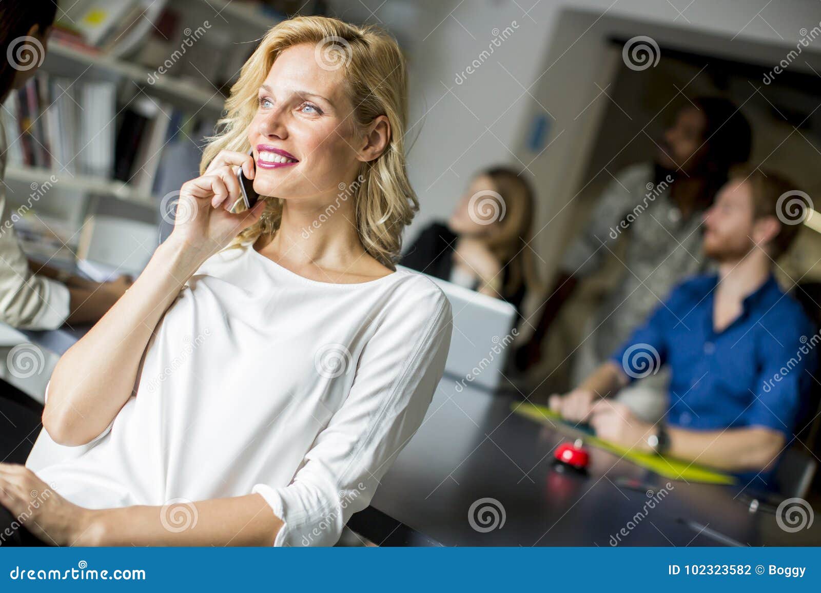Businesswoman Using Mobile Phone in Office and Other Business Pe Stock ... Businesswoman Using Mobile Phone in Office and Other Business Pe Stock ...